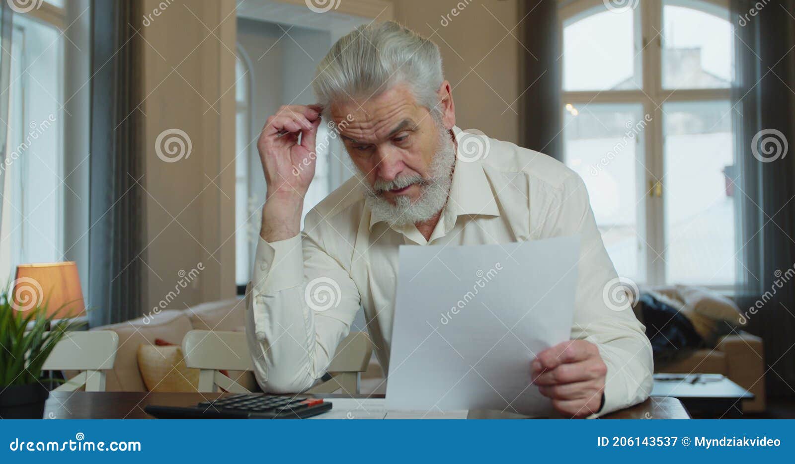 Old Senior Man Checking Home Finances and Bills, he is Calculating ...