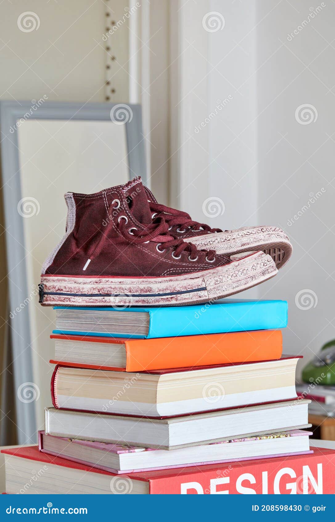 Old shoes on books stack stock photo. Image of attitude - 208598430
