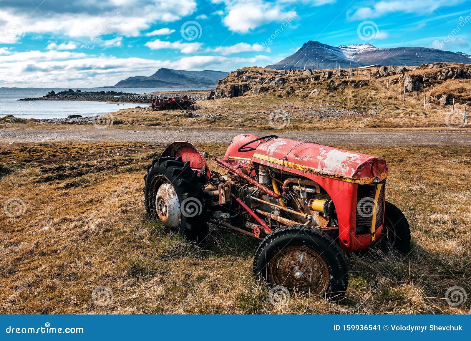 An Old Broken Tractor Stands Next To A House In The Village. Royalty ...