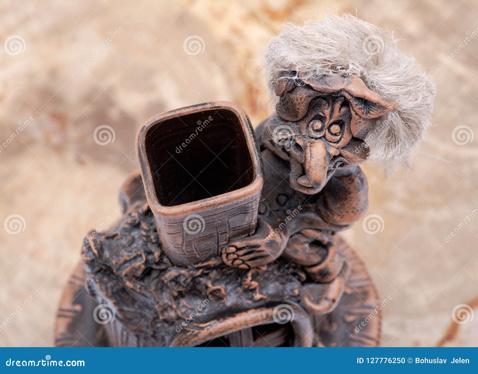 Old Smiling Witch Sitting on the Chimney and Petrified Wood Stock Photo ...