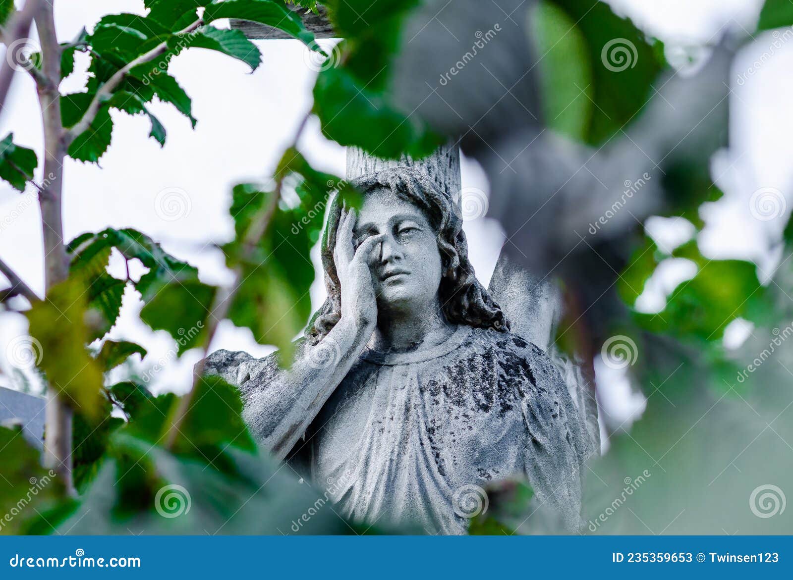 Old Statue of Weeping Stone Angel on Background of Green Leaves Stock ...