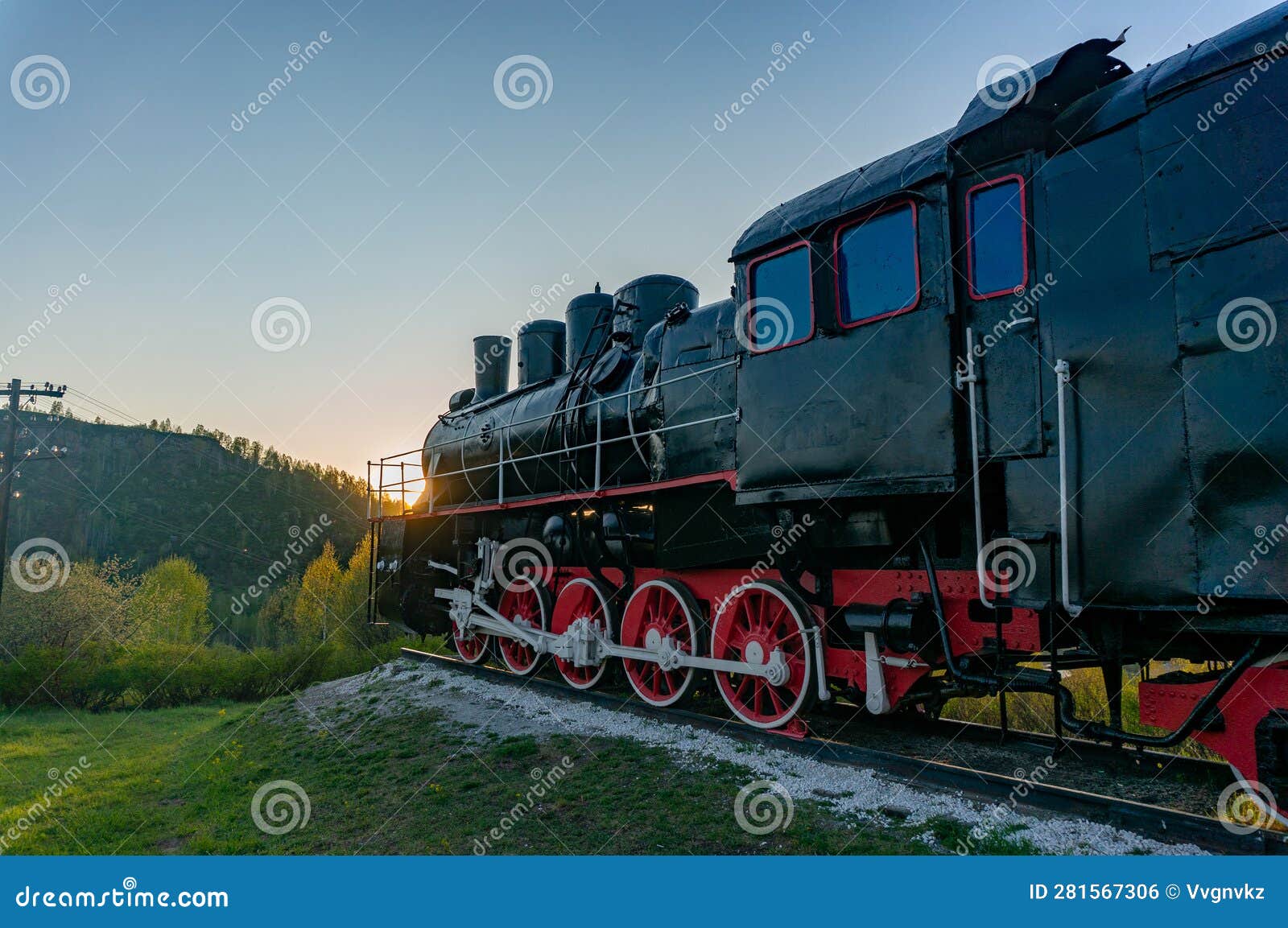 Old Steam Locomotive at the Station in the Rays of the Setting Sun ...