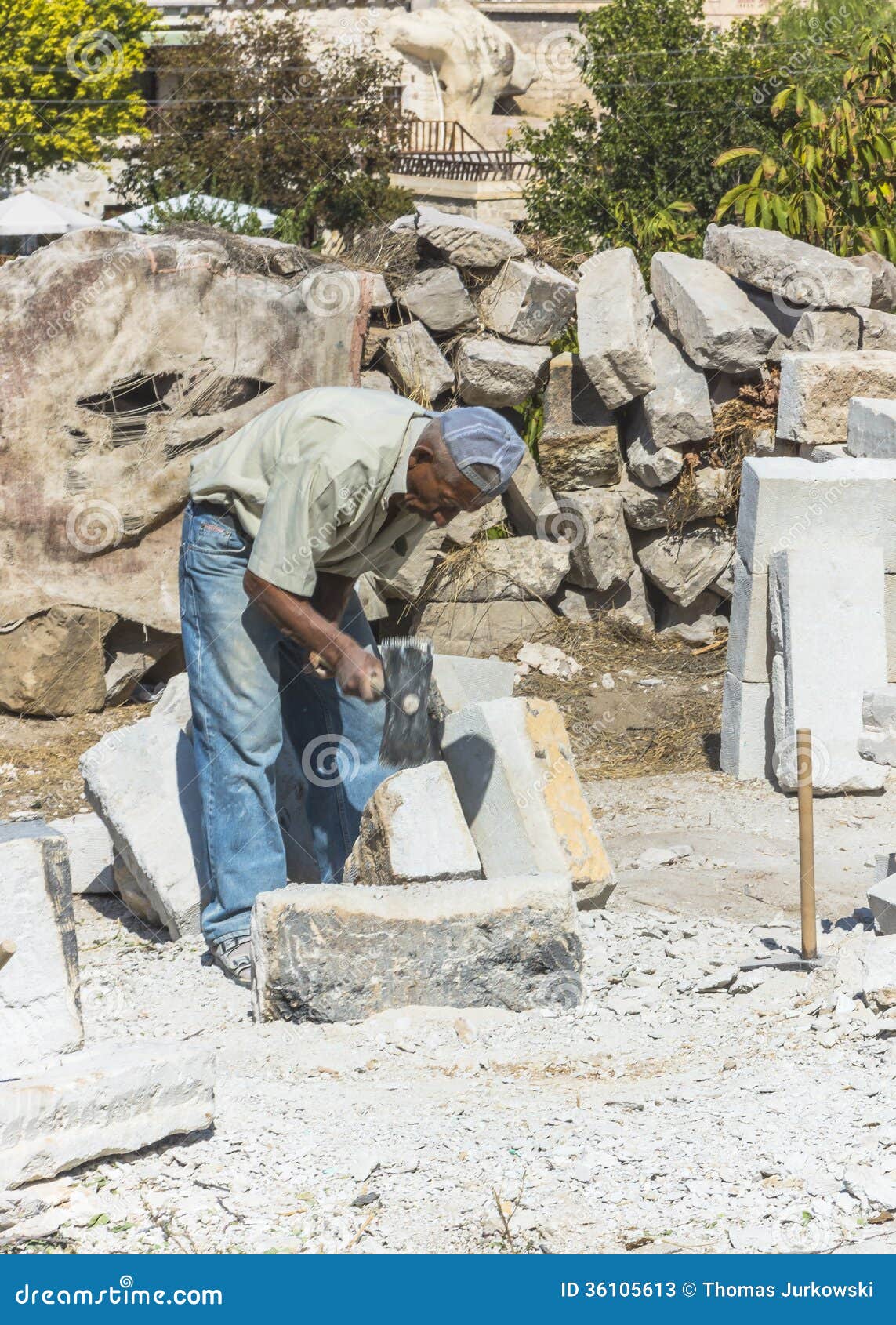 Stone Mason At Work On Major Roof Renovation Of Historic Building At ...