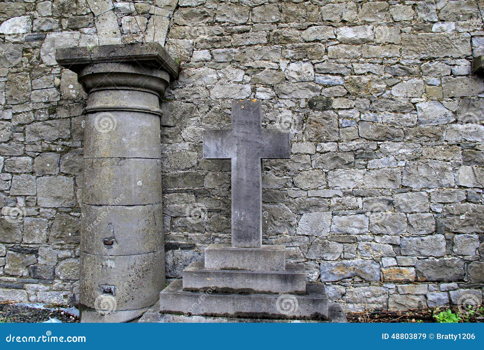 Old Stone Wall with Graveyard Cross and Column Resting Against it Stock ...