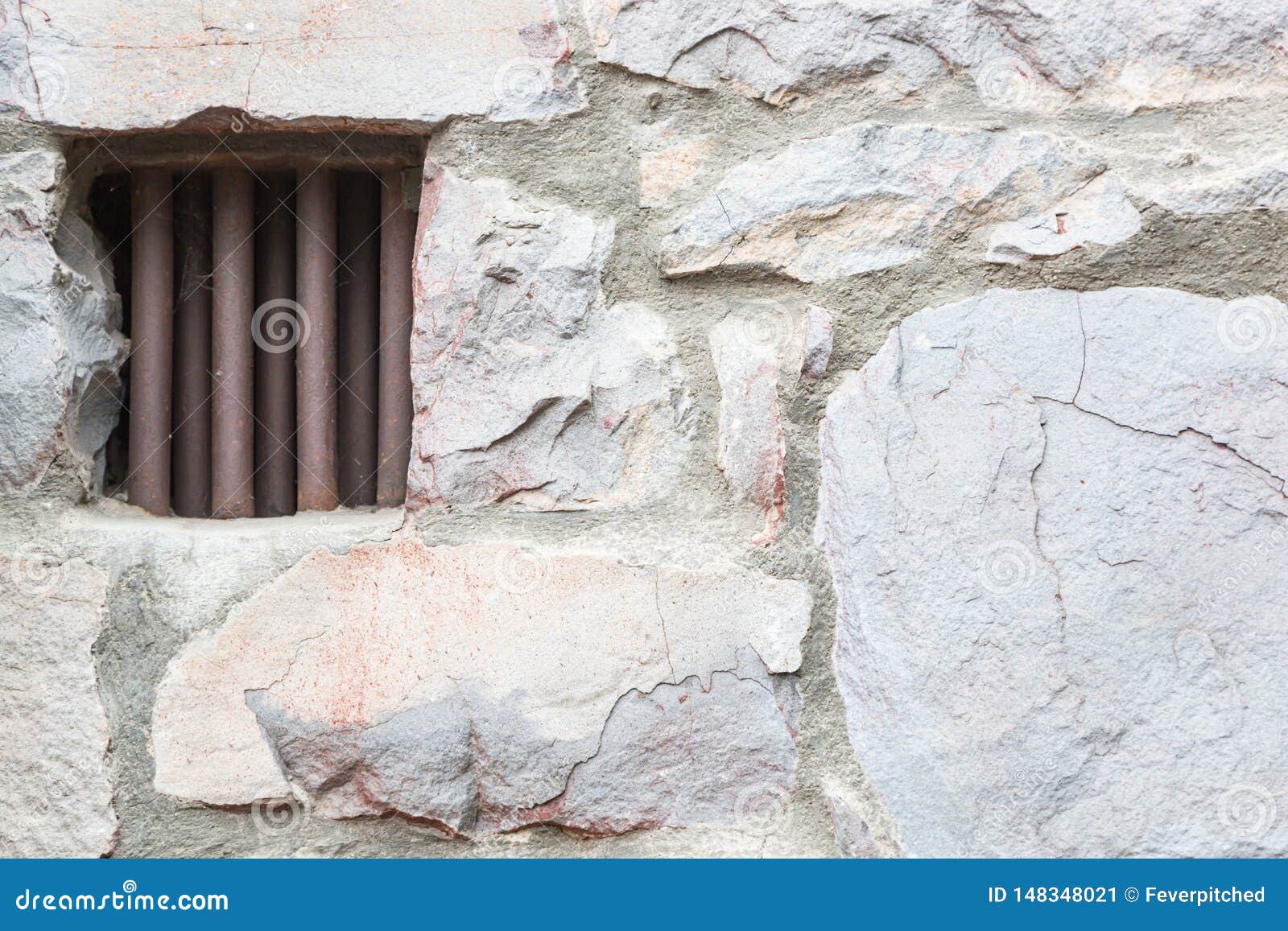 Old Stone Wall with Small Iron Barred Prison Cell Window Stock Image ...