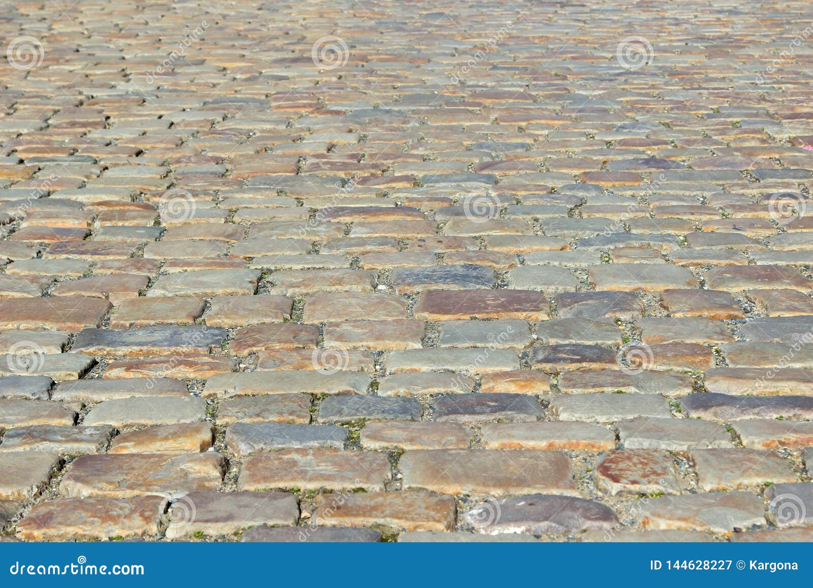 An Old Stoneblock Pavement Cobbled With Natural Stone Blocks With Gaps ...