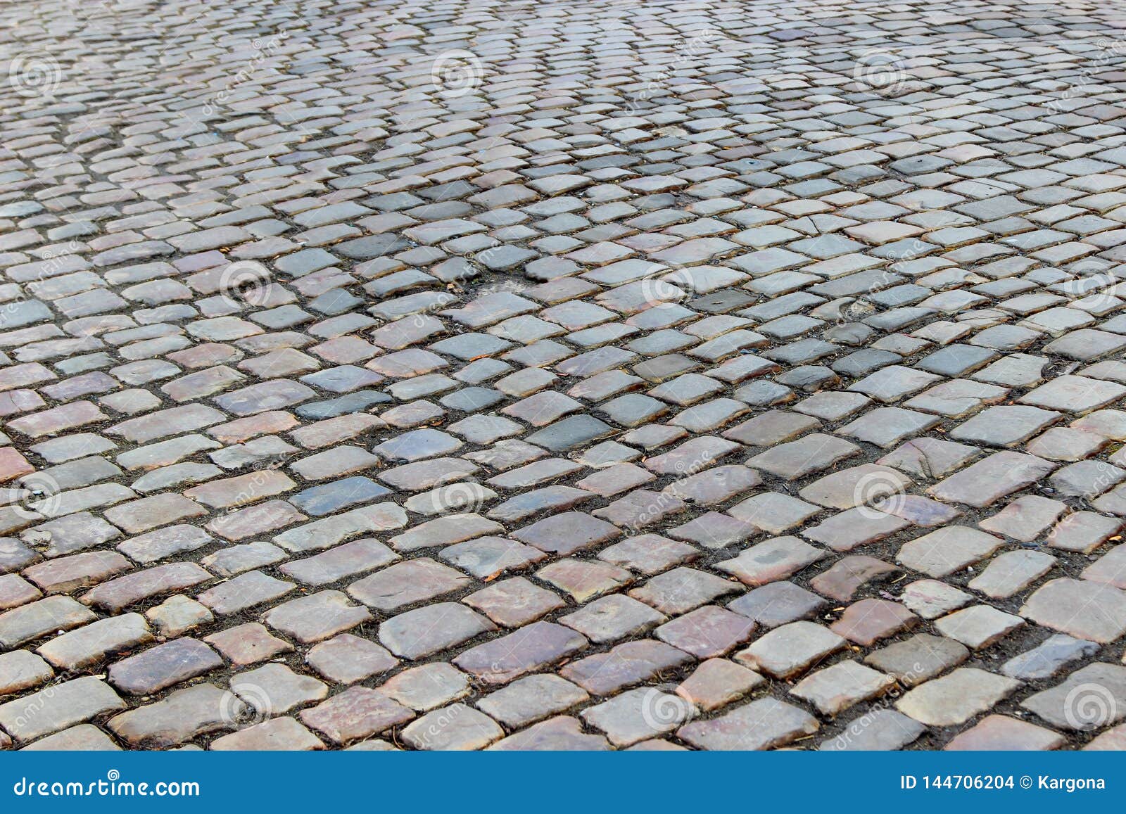 An Old Stoneblock Pavement Cobbled With Natural Stone Blocks With Gaps ...