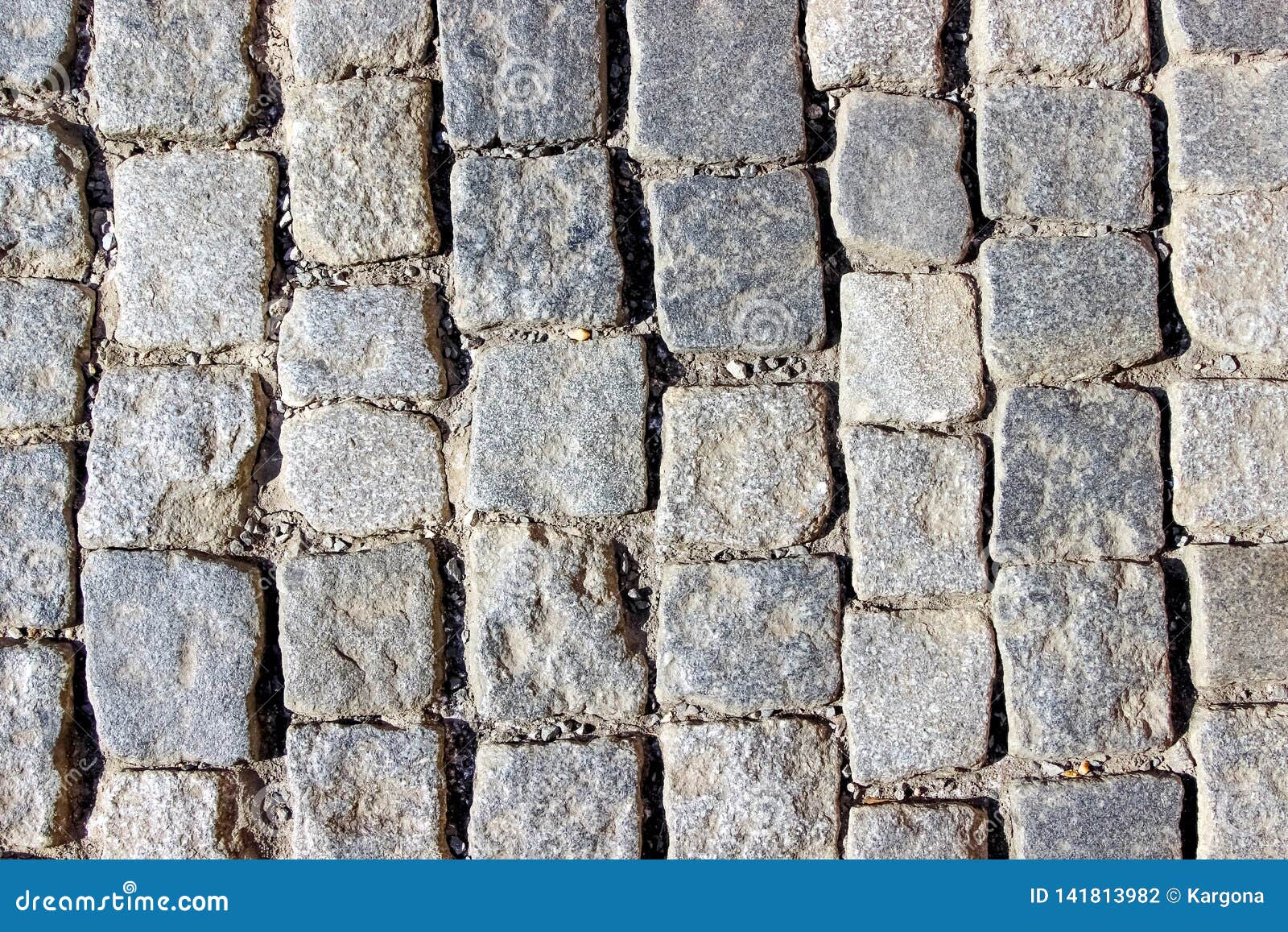 An Old Stoneblock Pavement Cobbled with Square Stone Blocks Stock Photo ...