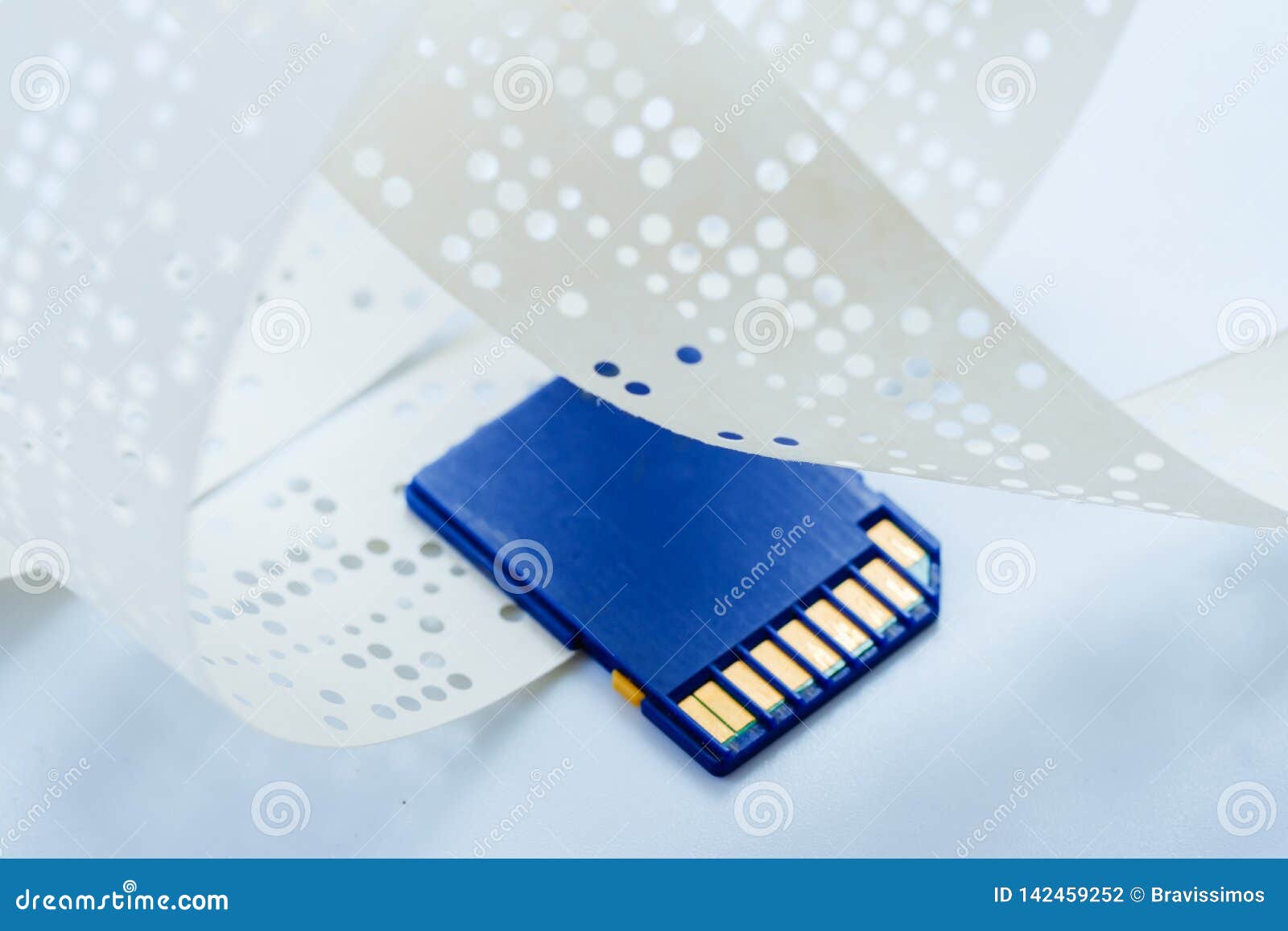 Old Storage Paper Obsolete Punched Tape and Sd Card, Technology Stock ...