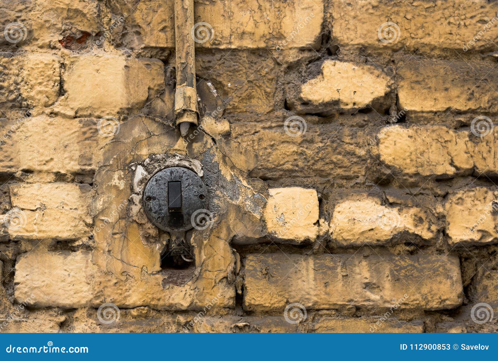 Old Street Light Switch on a Yellow Brick Wall Stock Image - Image of ...