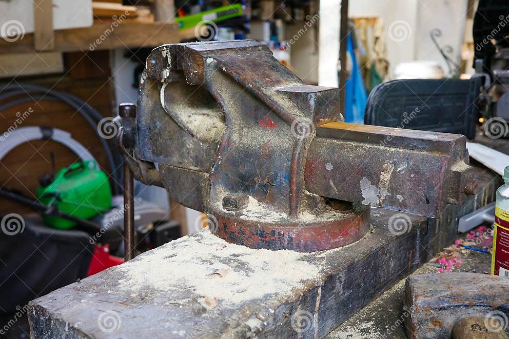Old, Sturdy Bench Vice on Workbench in Cluttered Workshop, Ready for ...