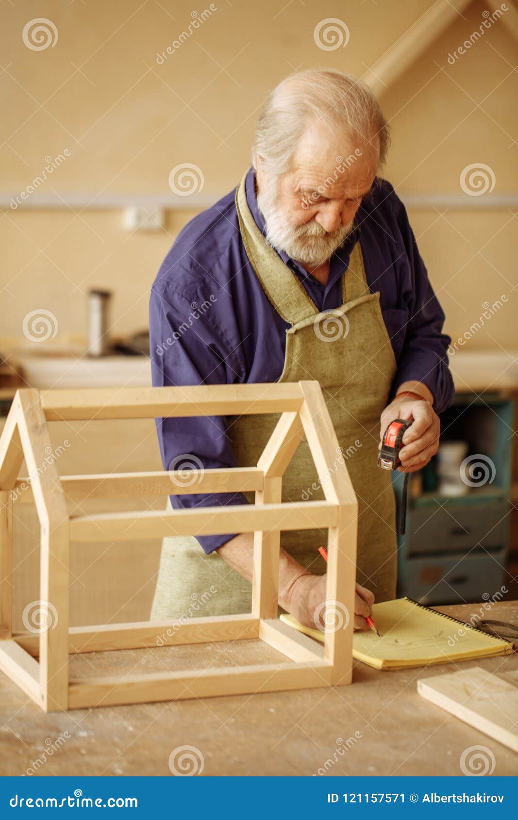 Old Successful Carpenter Writing Sceleton Plan in the Notepad Stock ...