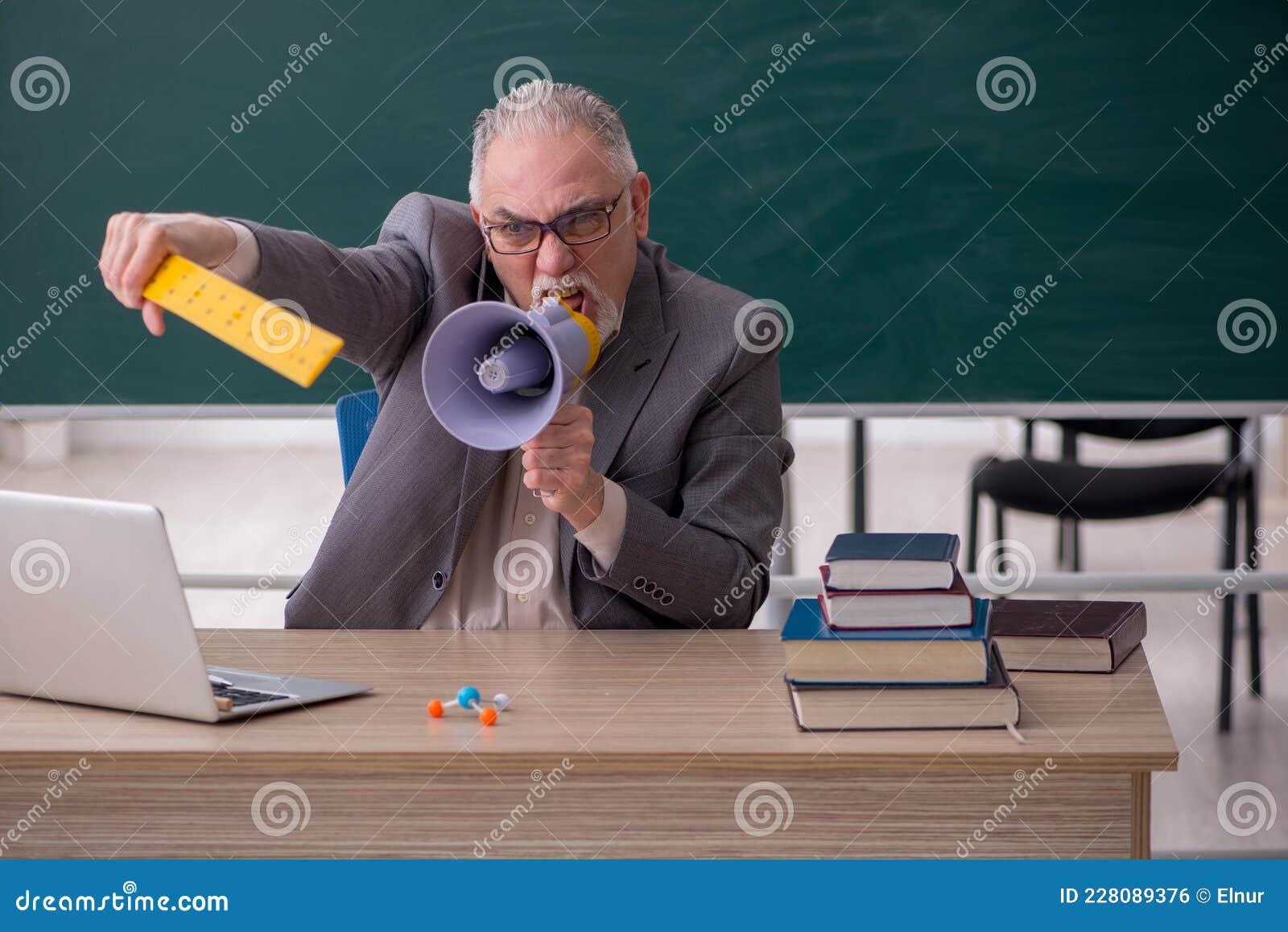 Old Male Teacher Holding Megaphone in Front of Blackboard Stock Photo ...