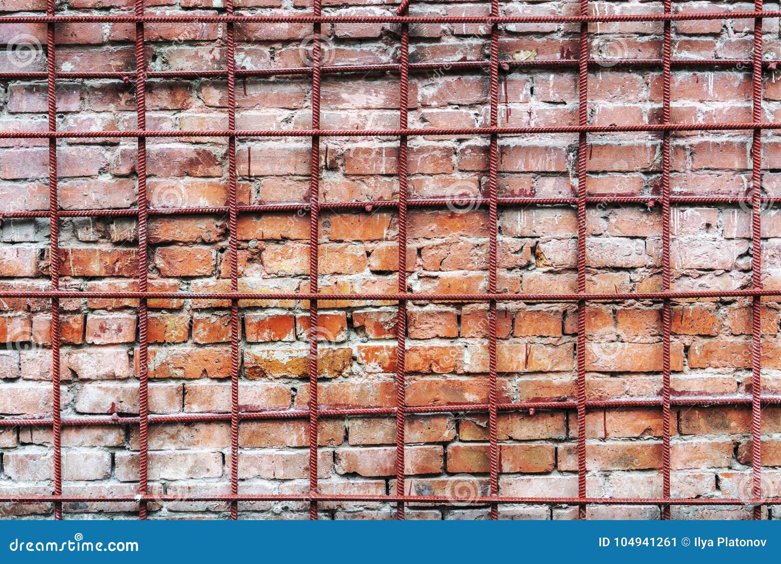 An Old and Time-worn Red Brick Wall Behind a Metal Grating Stock Image ...