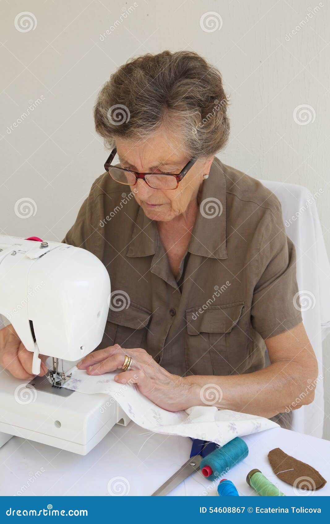 An Old Tired Woman Who is Working on a Sewing Machine Stock Image ...