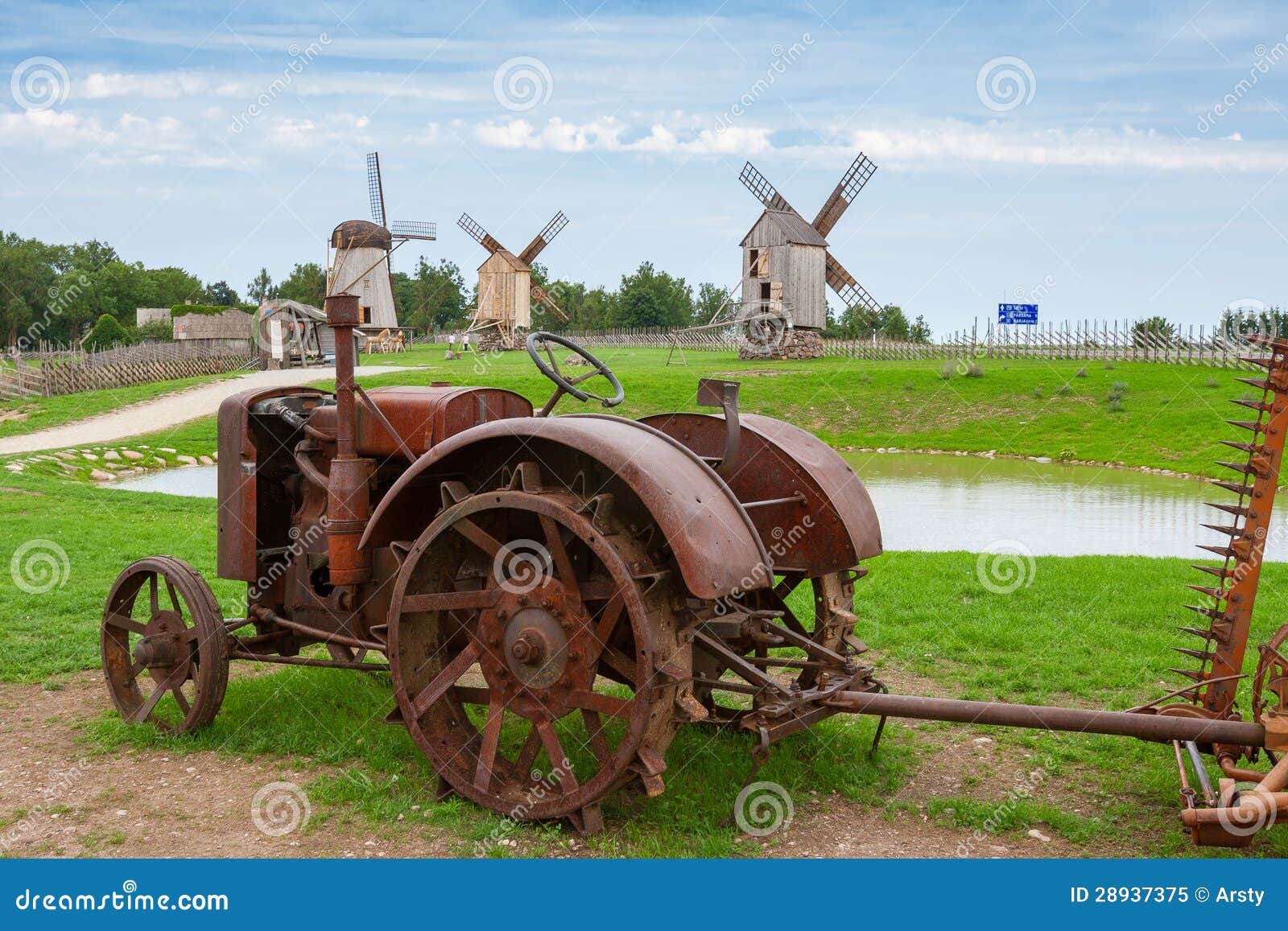 Old Tractor and Windmills. Estonia Stock Image - Image of green ...