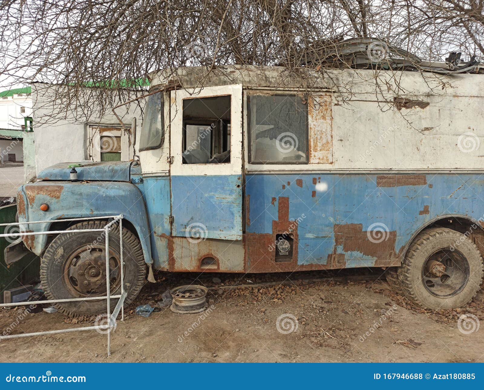 An Old Two-tone Abandoned Bus Covered in Rust Stock Photo - Image of ...