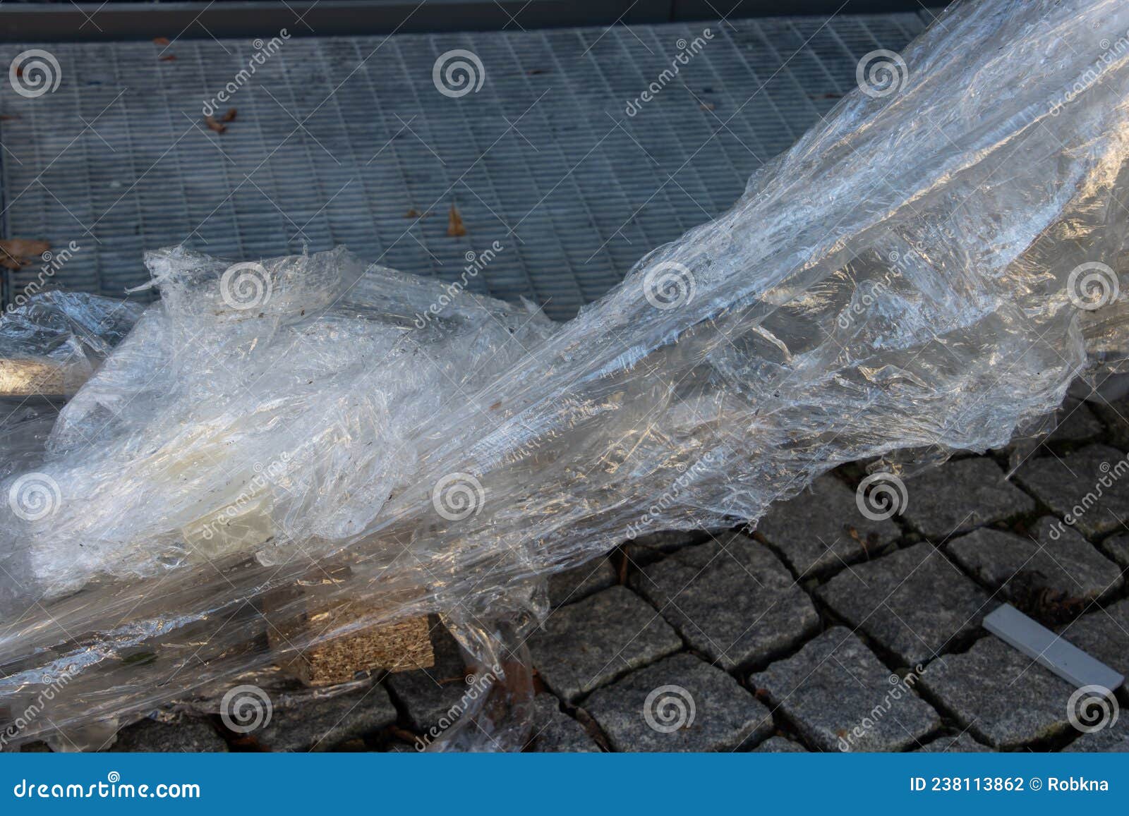 Old Used Plastic Wrap Lying on the Sidewalk Stock Photo - Image of ...
