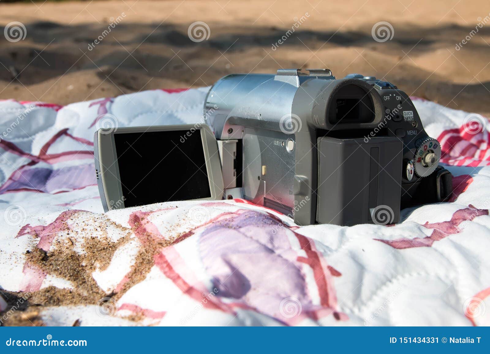 Old Video Camera on the Beach, on a Colored Bedspread, on the Sand ...