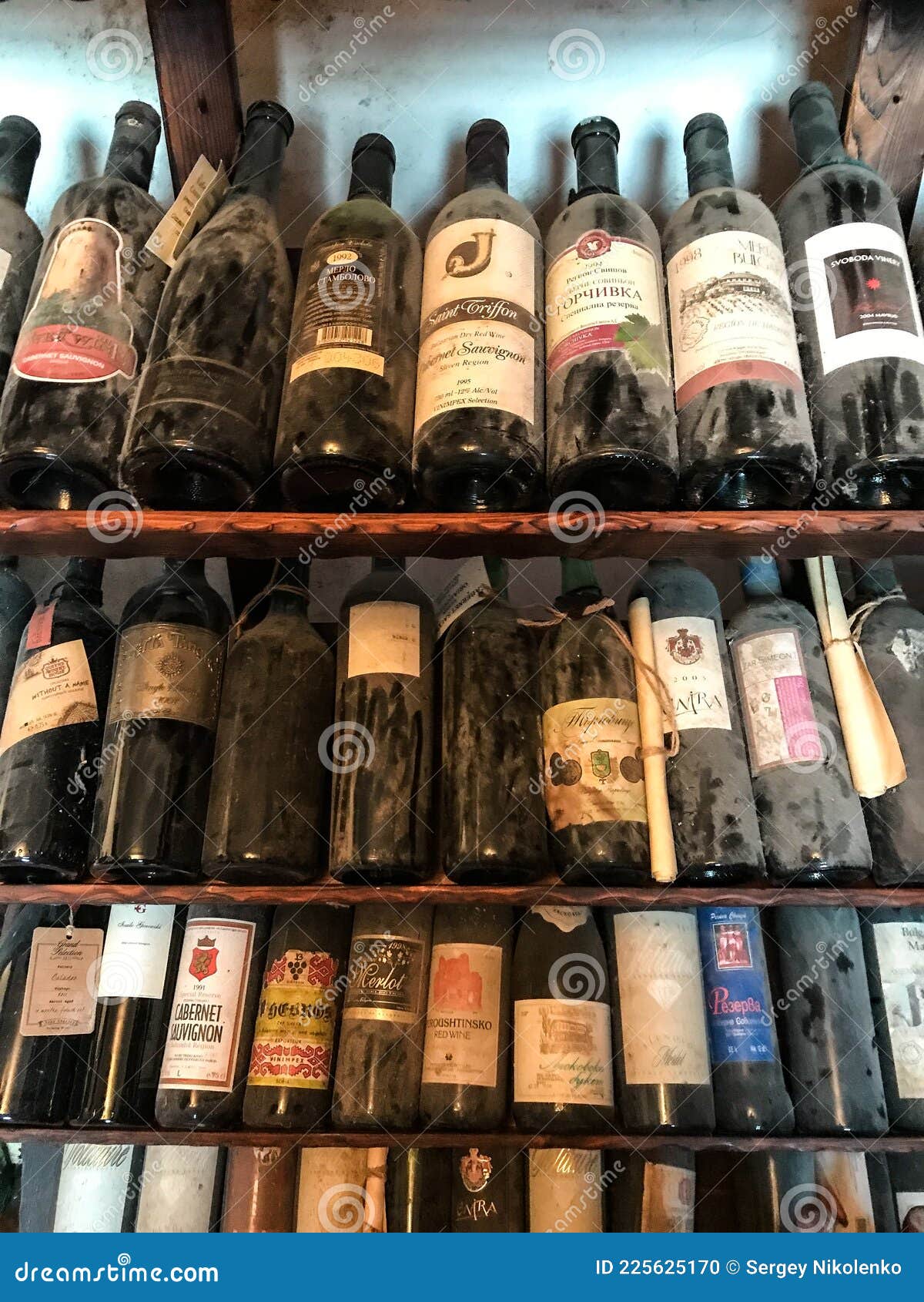 Old Vintage Dusty Wine Bottles in the Wine Cabinet Editorial Image ...