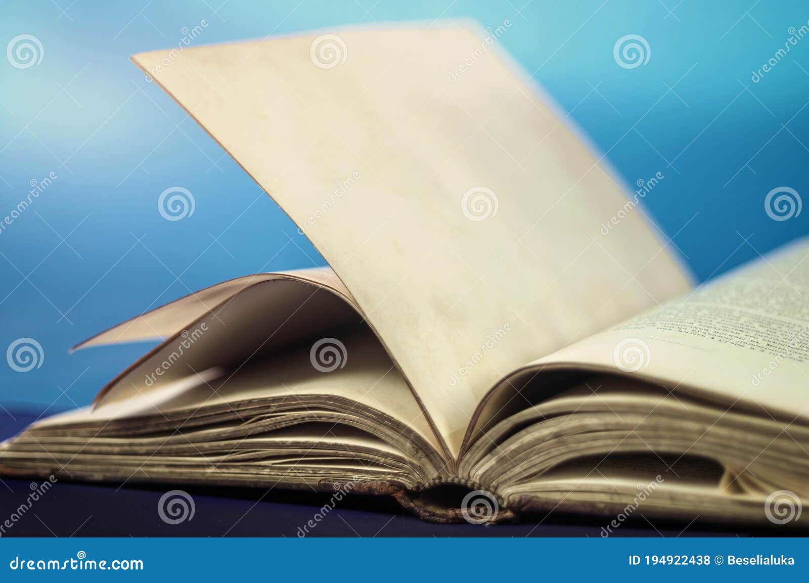 Old Vintage Opened Book with a Light Blue Background Stock Photo ...