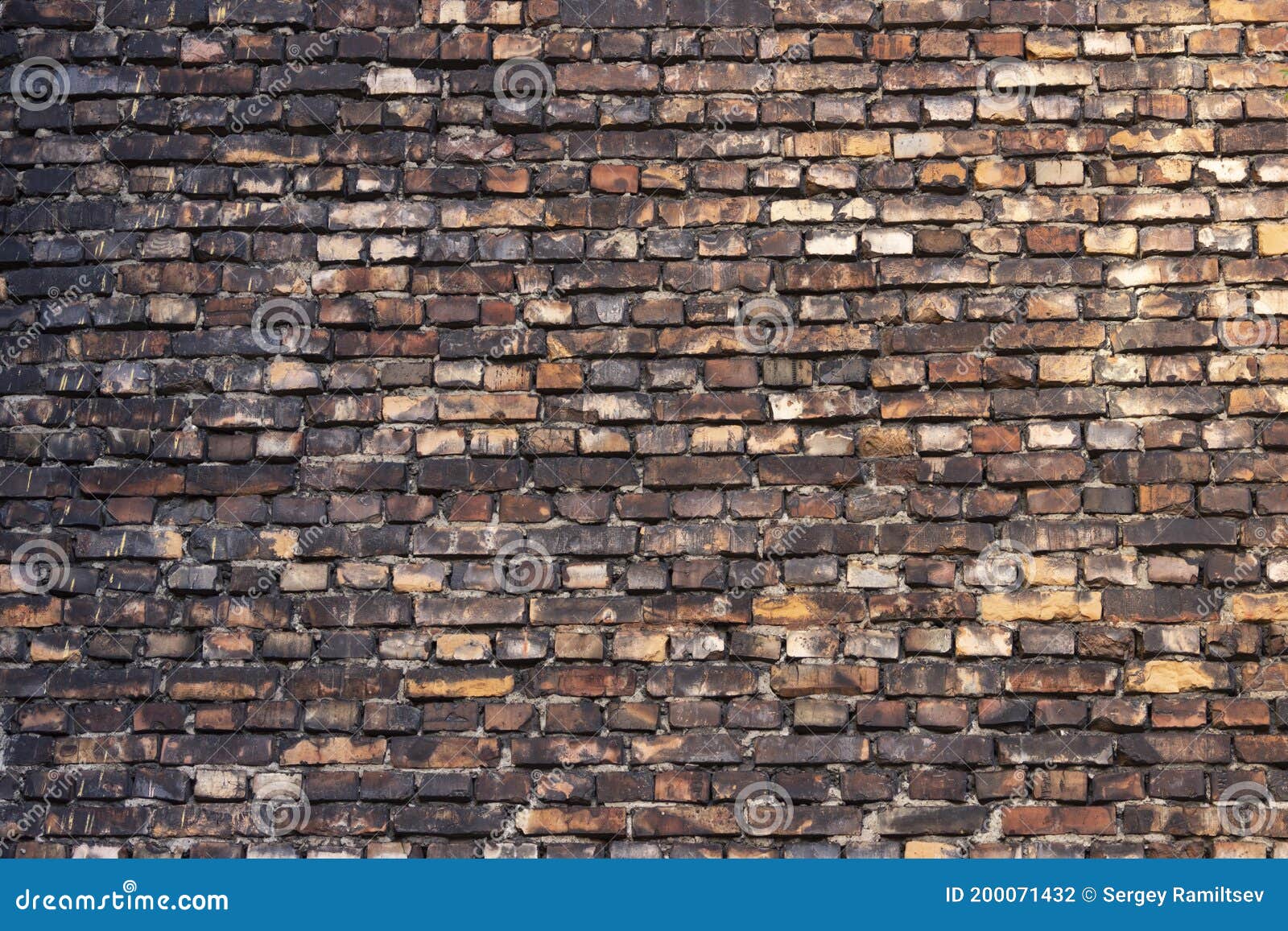 The Old Wall of the Building is Made of Multi-colored Bricks, Darkened ...