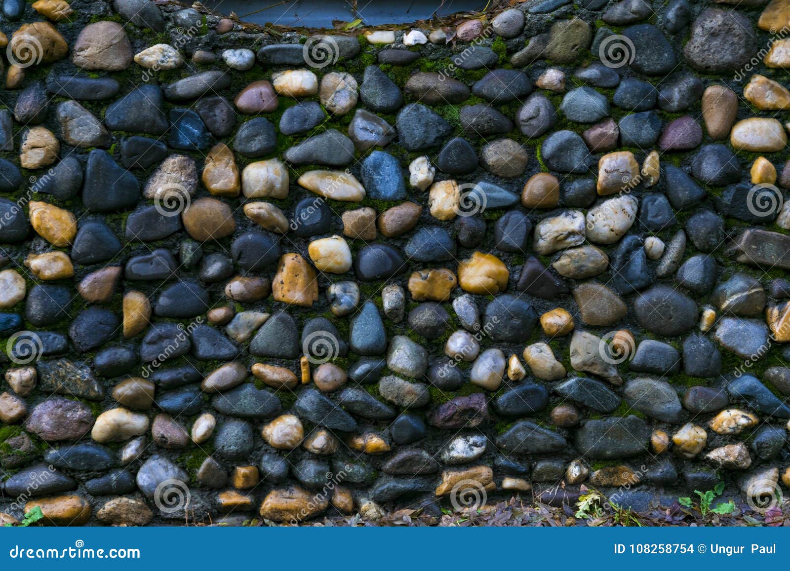 A wall made of round rocks stock photo. Image of structure - 108258754