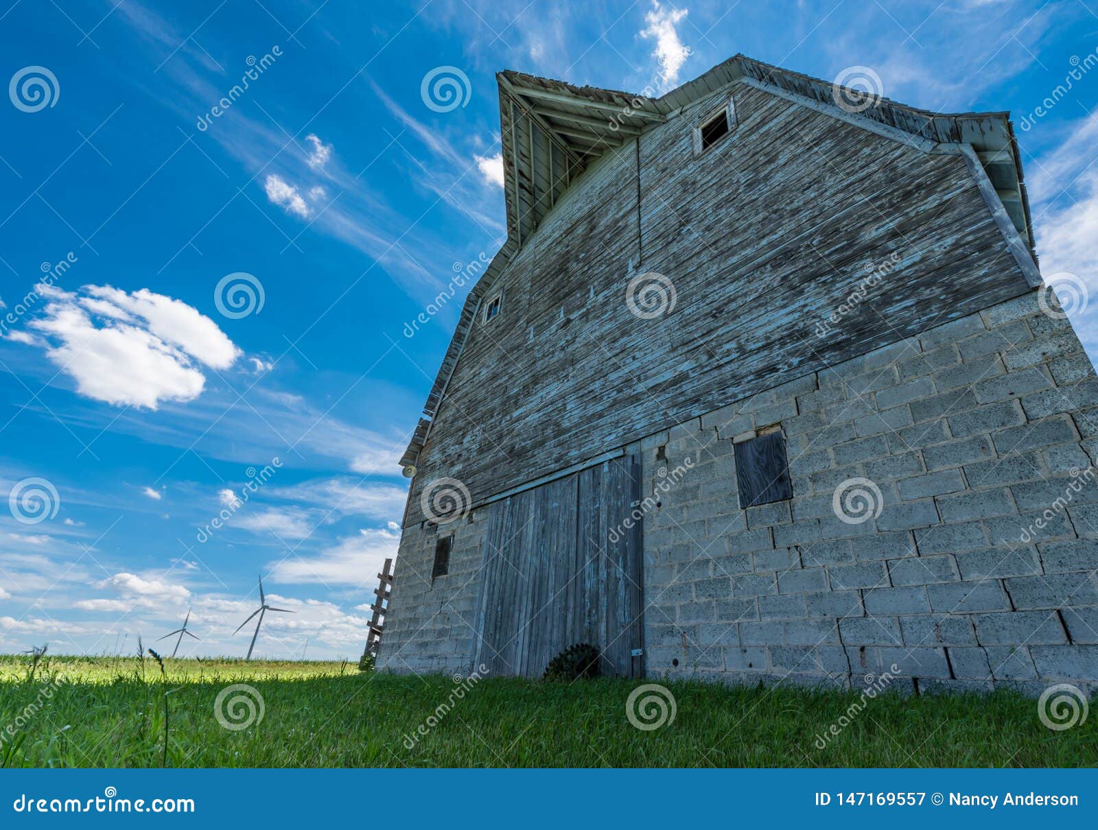 Old Weathered Barn with Wind Turbines in the Background Stock Image ...