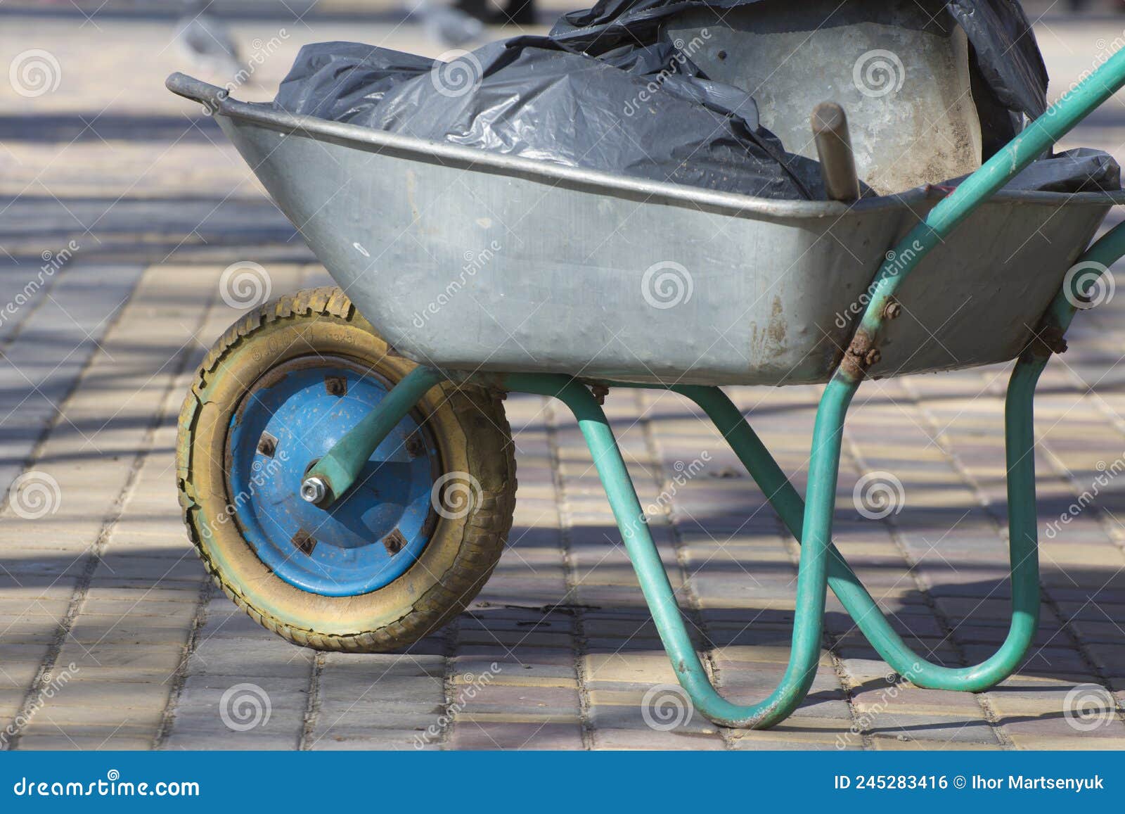 Old Wheelbarrow with Garbage. Street Cleaning by Public Utilities in ...