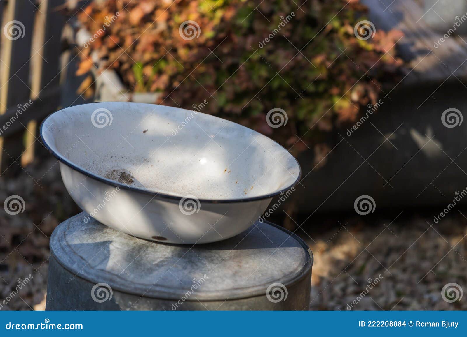 An Old White Water Container Stands on a Tin Barrel Stock Photo - Image ...