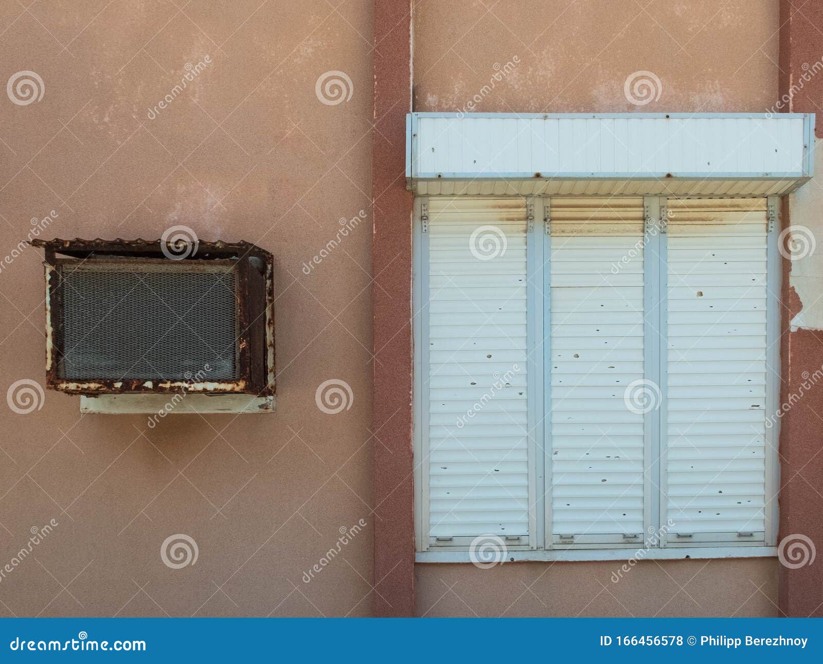 Old Window Air Conditioner and Window with Closed Rolling Shutter Stock ...