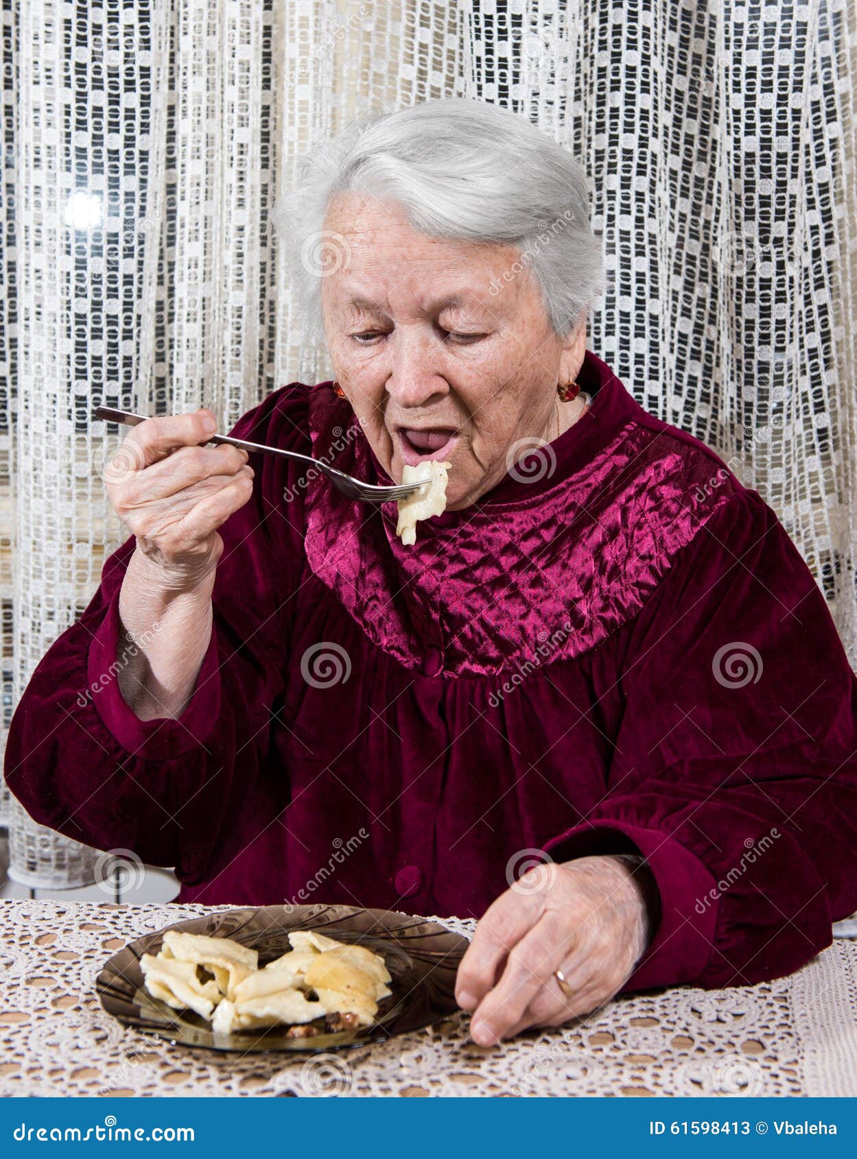 Old woman eating at home stock image. Image of mature - 61598413