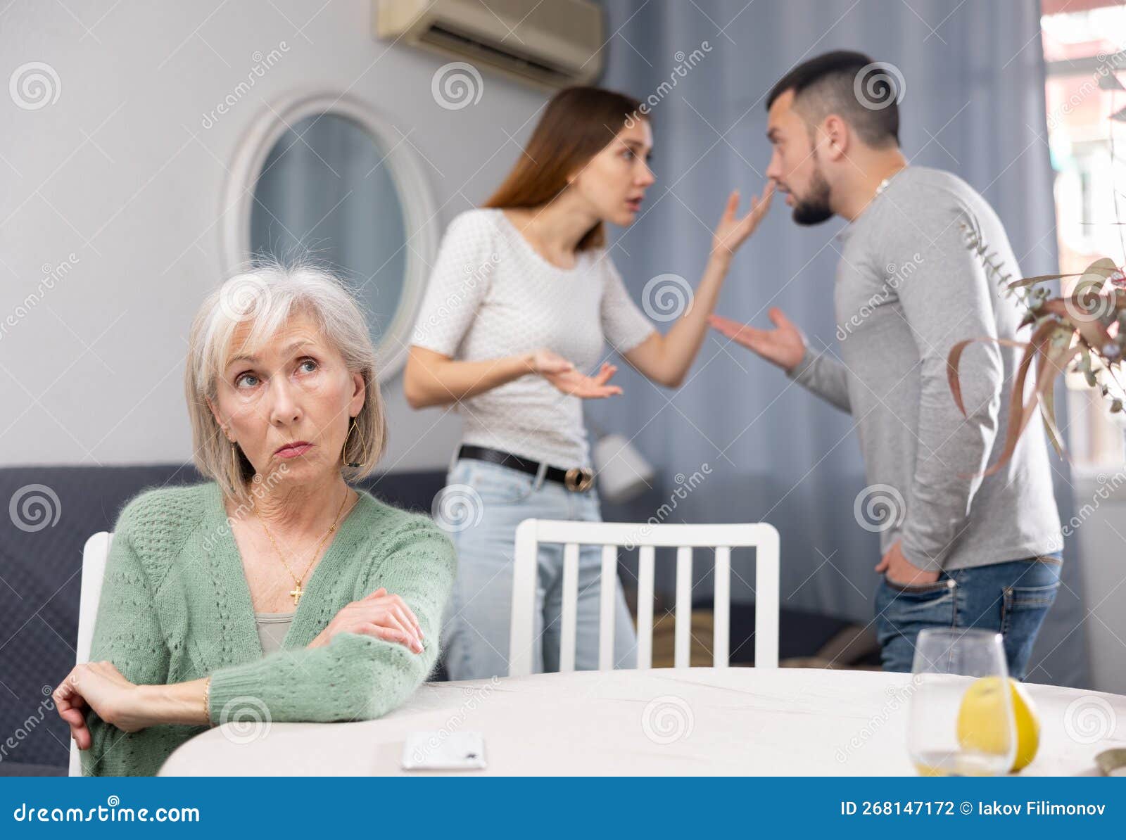 Old Woman Ignoring Her Daughter And Son In Law Arguing With Each Other