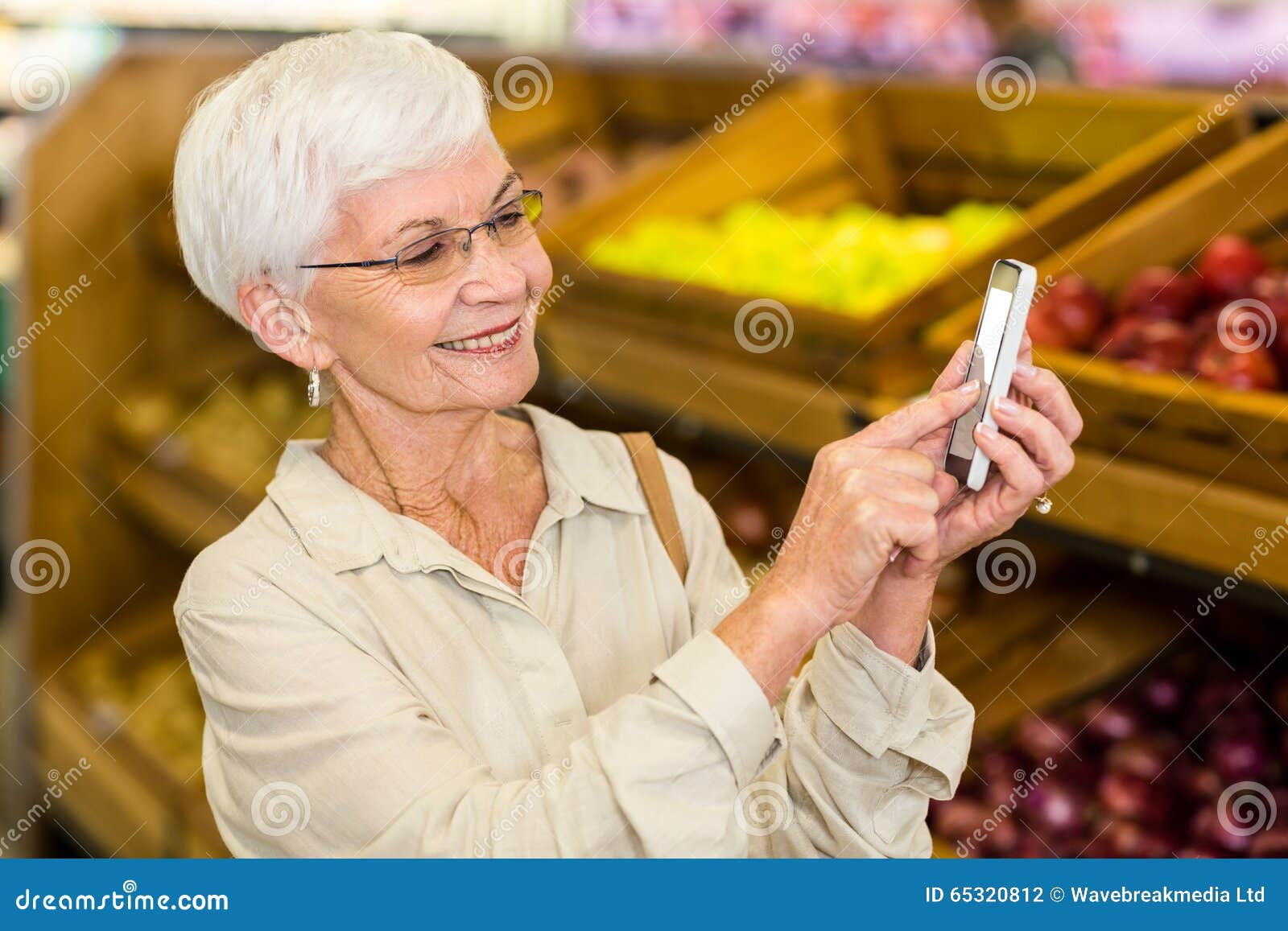 Old Woman Using Her Smartphone Stock Photo - Image of clothing, indoors ...