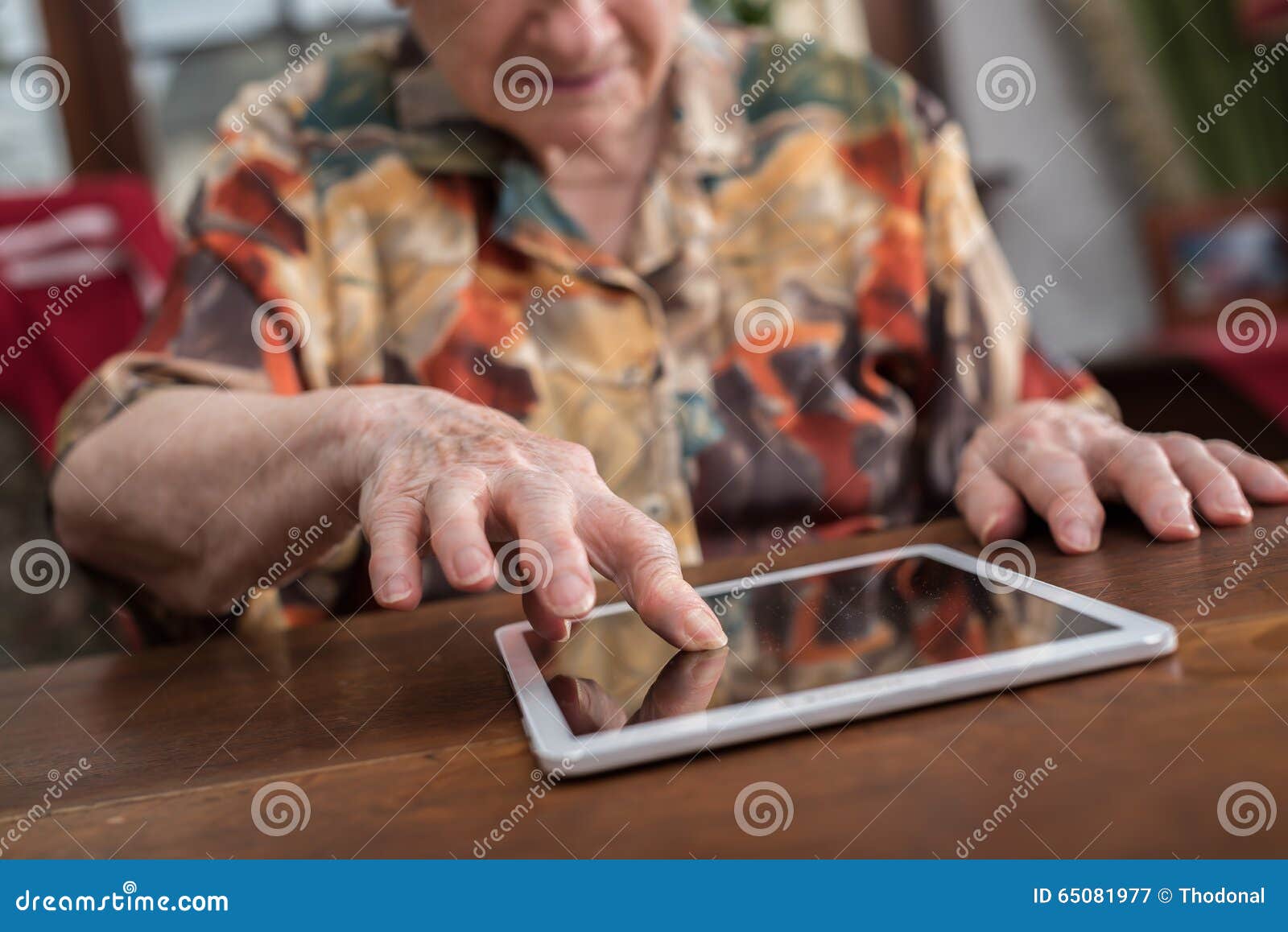 Old woman using a tablet stock image. Image of modern - 65081977