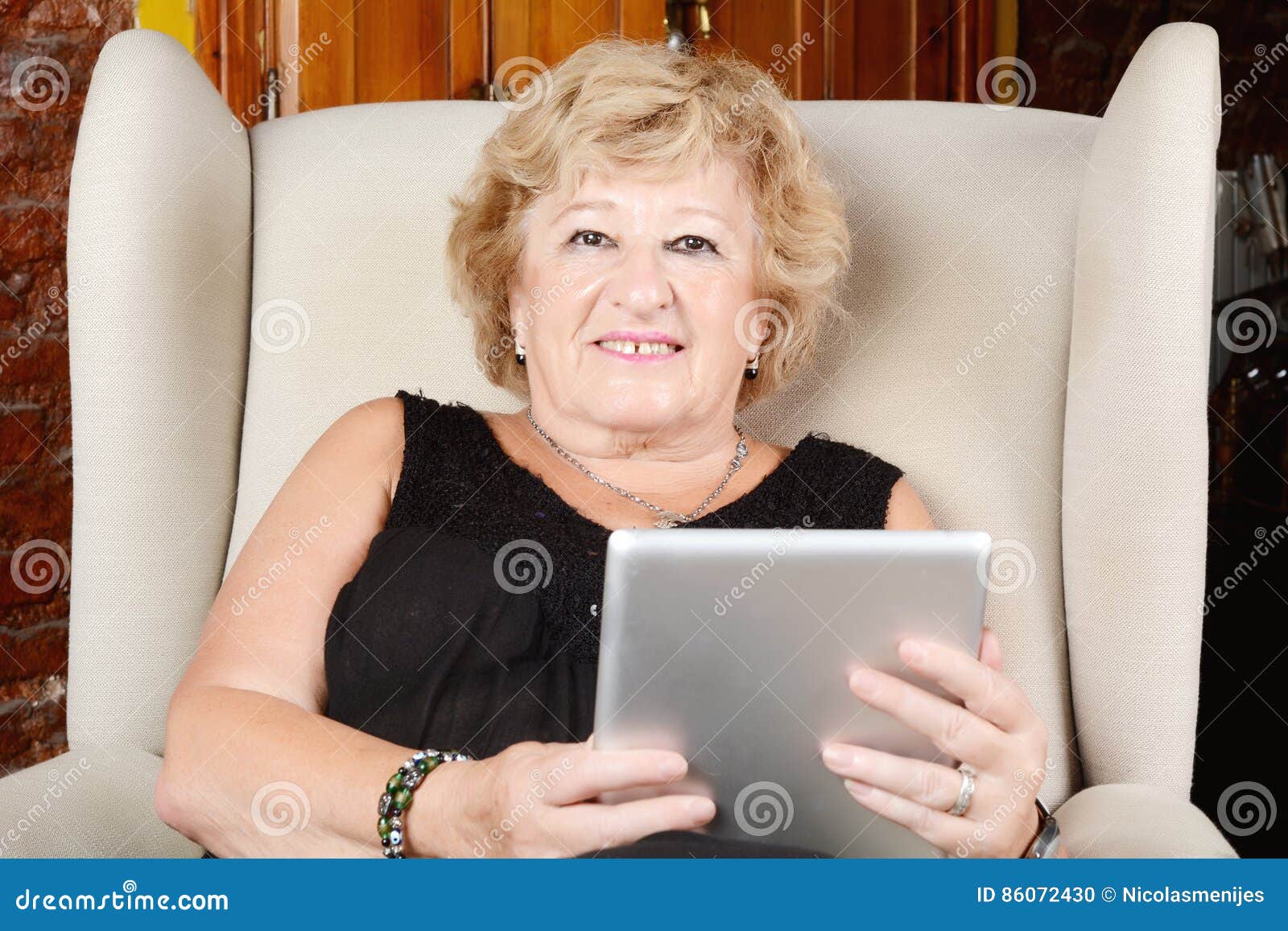 Old woman using tablet. stock photo. Image of attractive - 86072430
