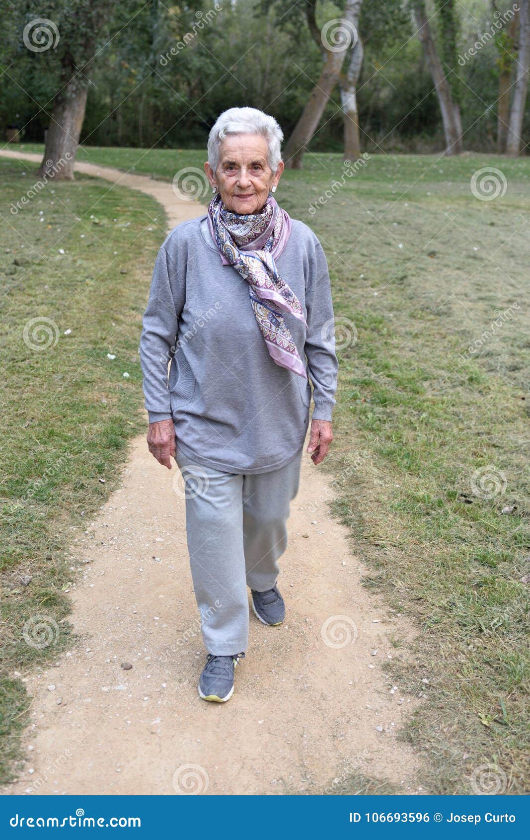 Old Woman Walking in a Park Stock Photo - Image of caucasian, camera ...