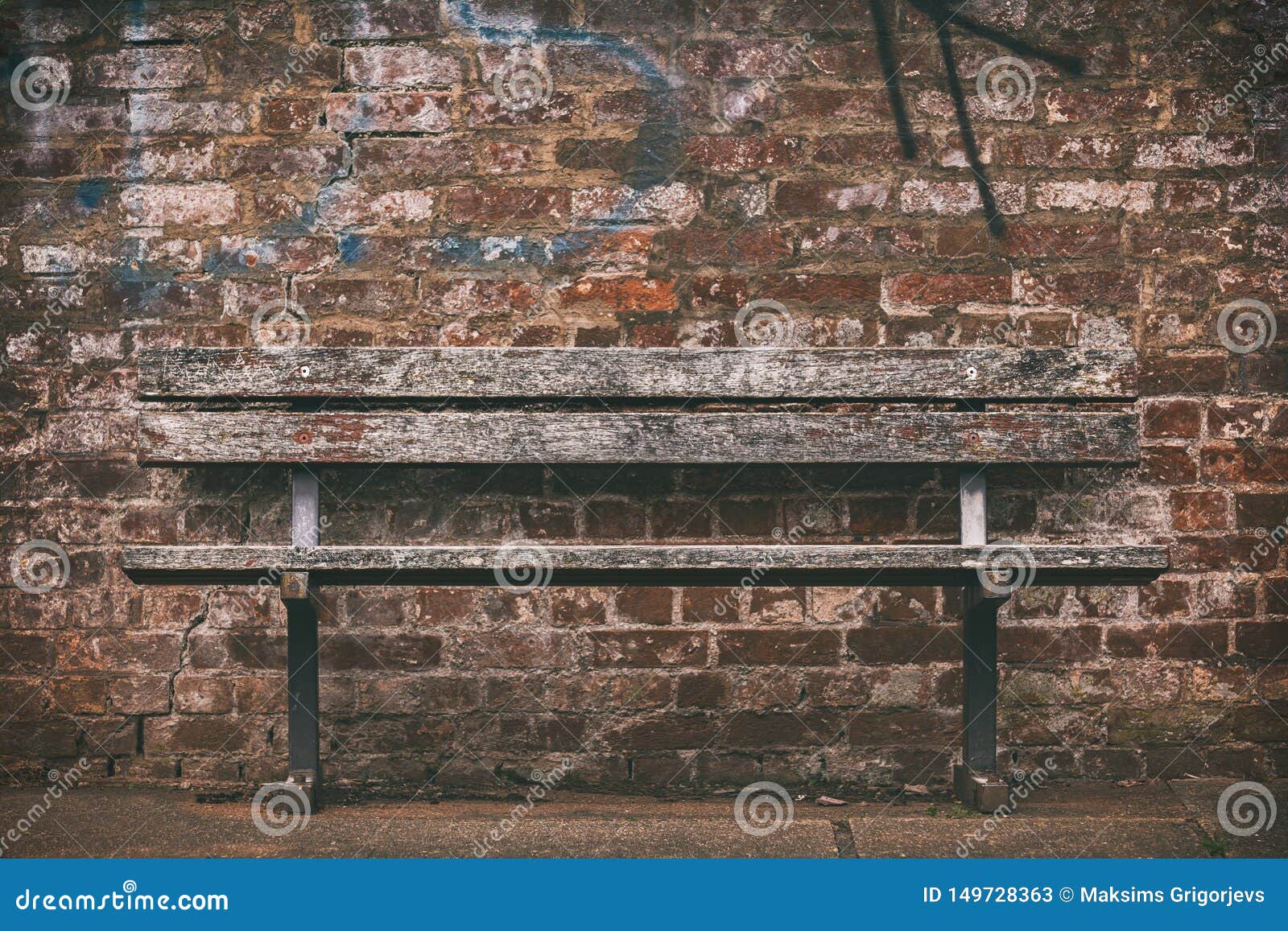 Old Wooden Bench Against a Brick Wall with Graffiti Stock Image - Image ...