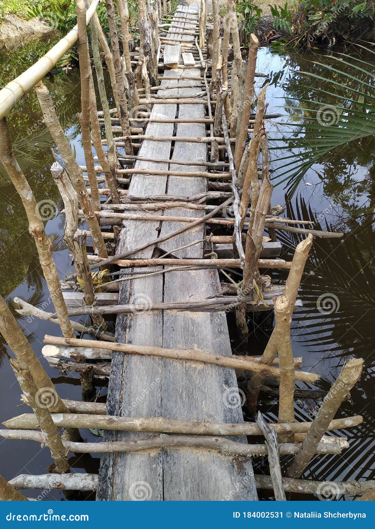 Old Wooden Bridge Over the River. Rustic Bridge in Asia. Rural ... Old Wooden Bridge Over the River. Rustic Bridge in Asia. Rural ...