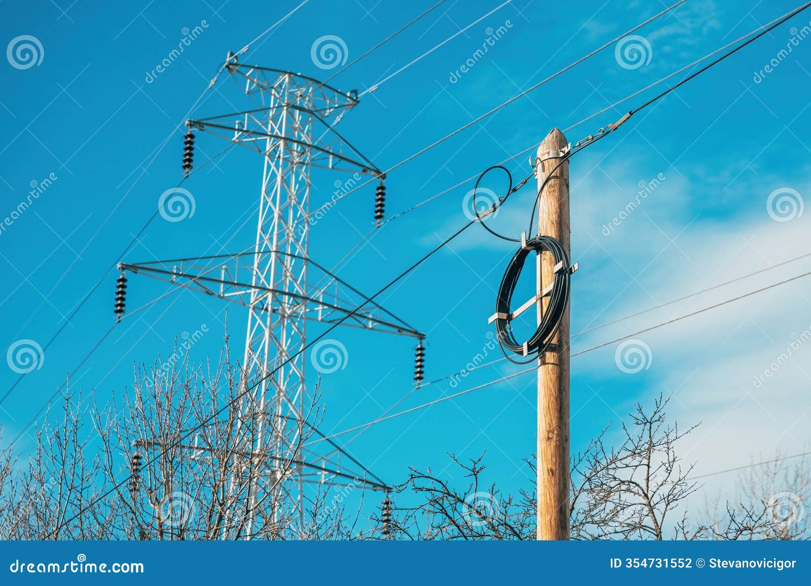 Old Wooden Electricity Pole and Overhead Powerline Tower Stock Photo ...