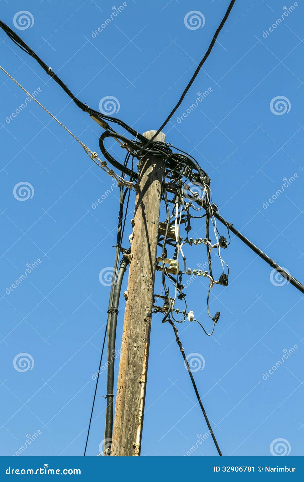 A Wooden Powerline Pole With The Powerline Coming Into The Ground And ...