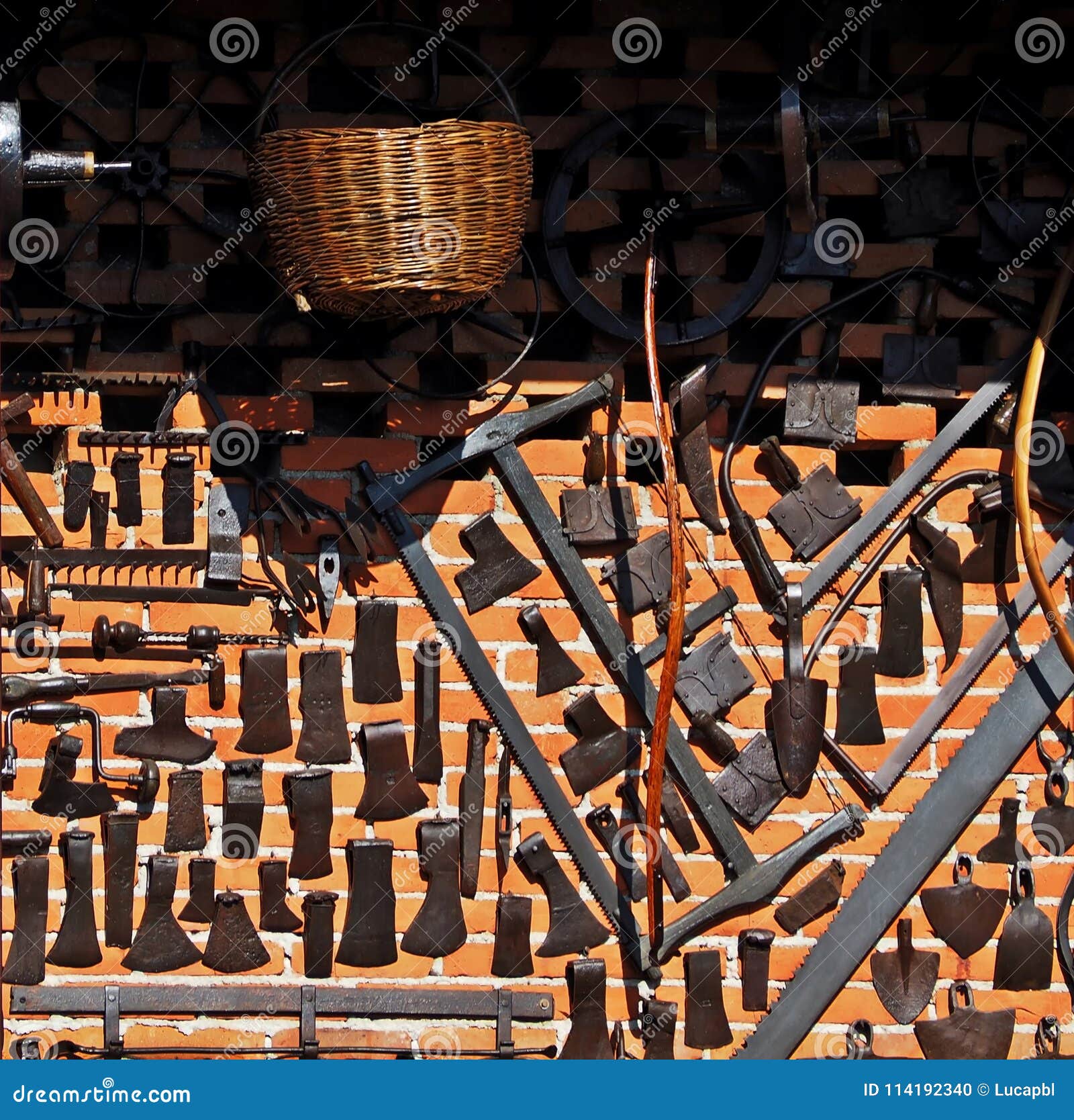 Old Woodworking Tools and Agricultural Tools Hung on a Brick Wall Stock ...