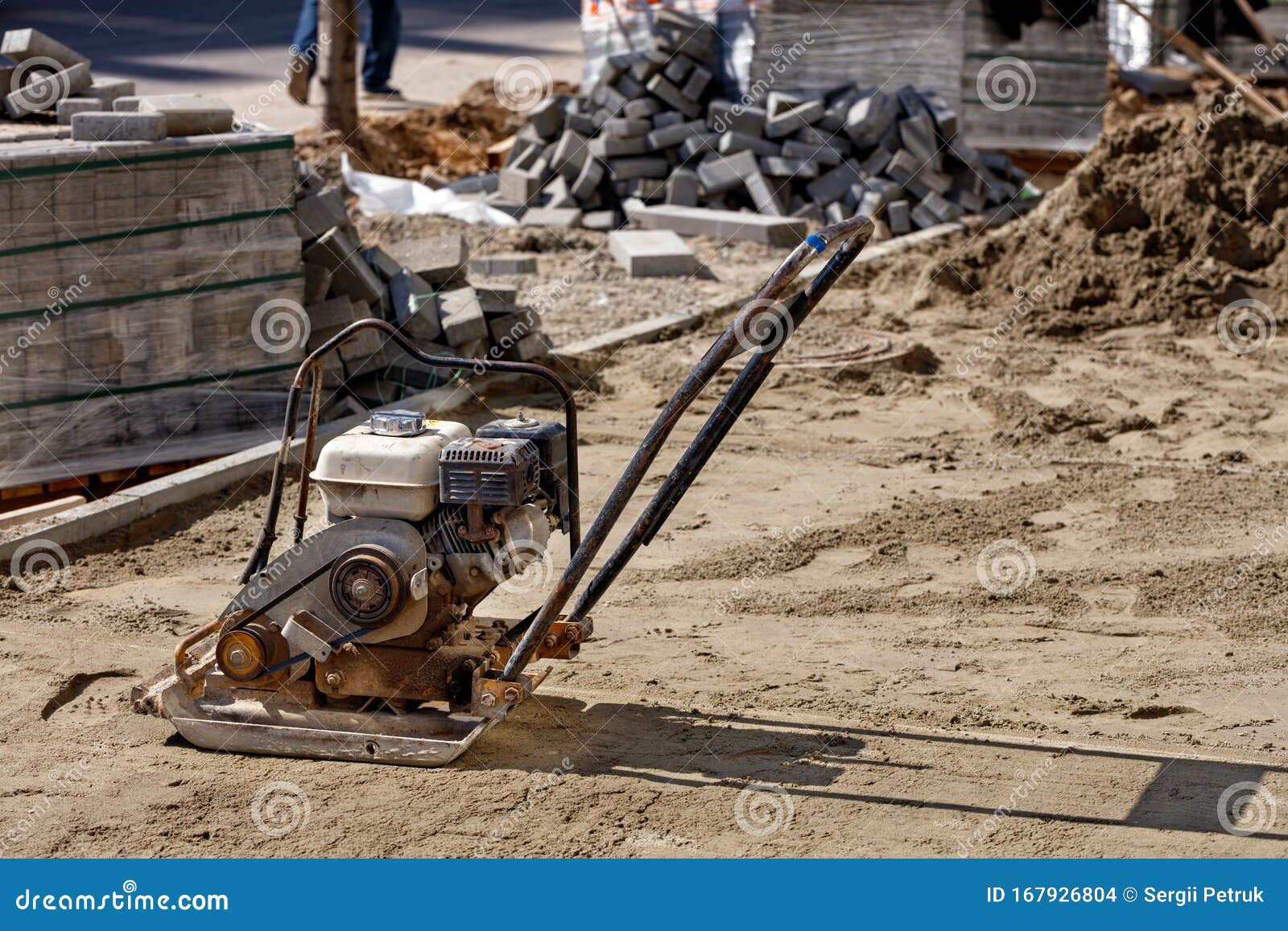 An Old Gasoline Compactor for Compacting Sandy Soil Stands Opposite a ...
