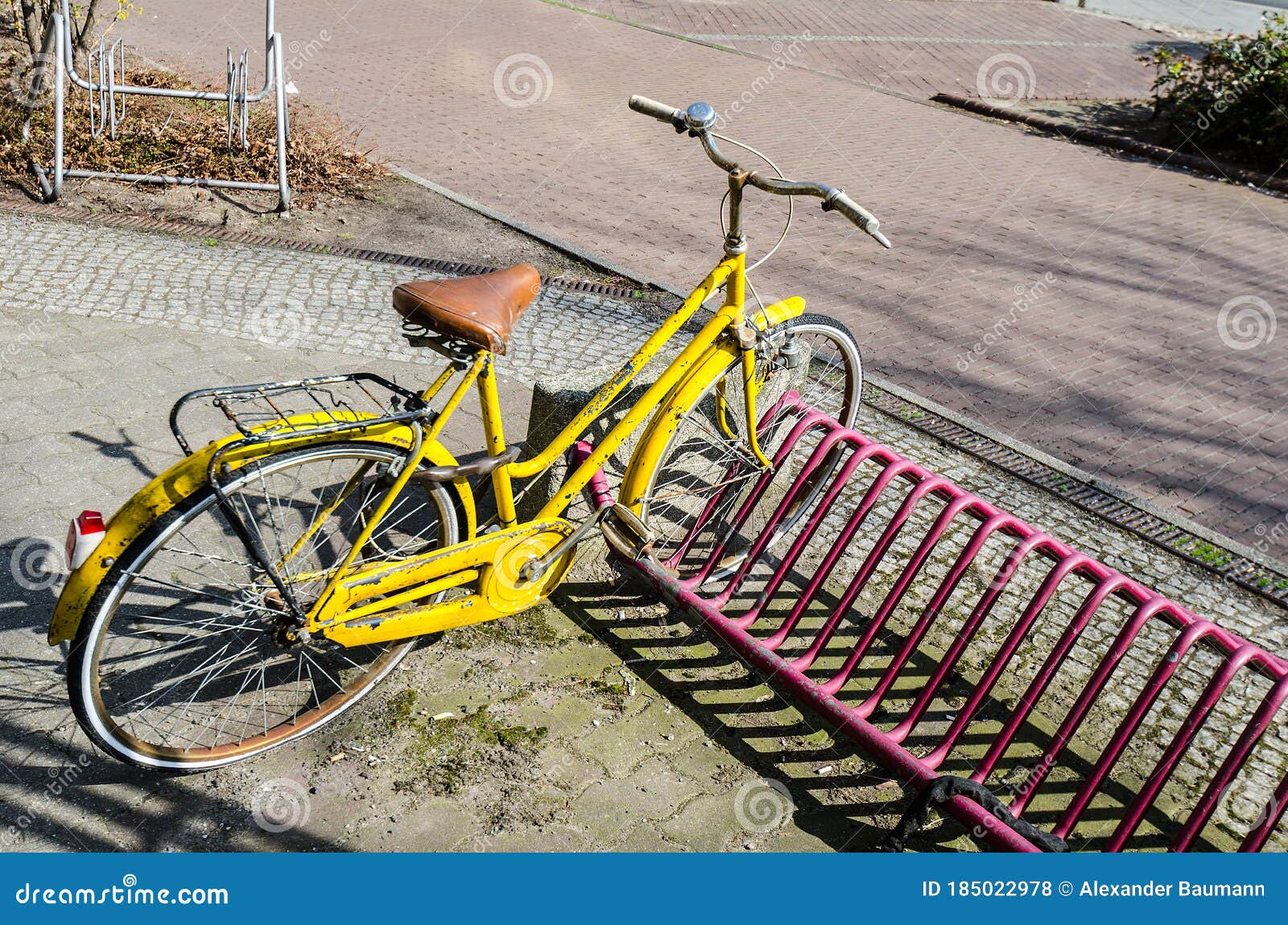 Old Yellow Bicycle in Pink Bicycle Stands Stock Photo - Image of stands ...