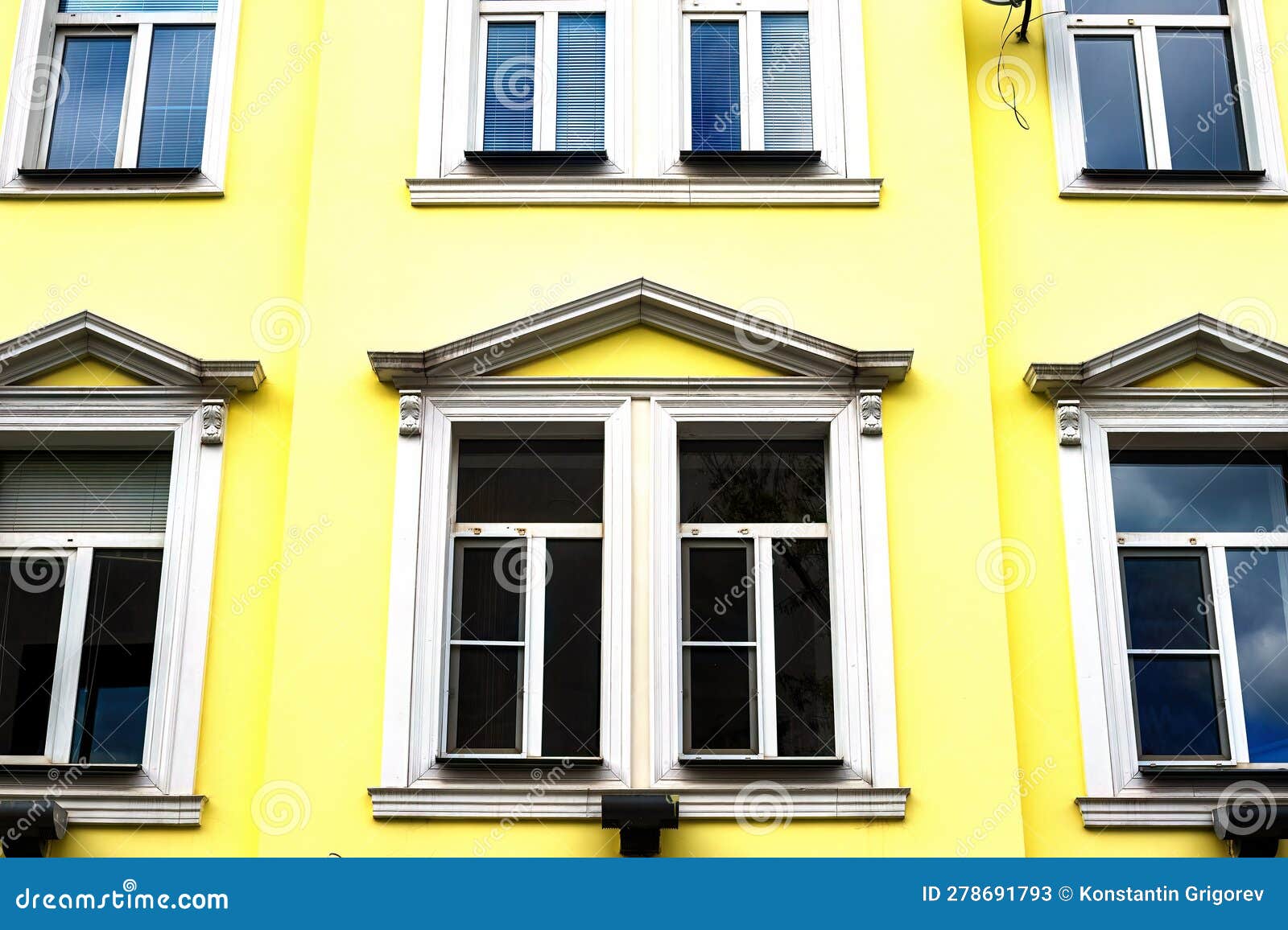 Old Yellow House Facade in Classical Style. Decorated Window Frames ...