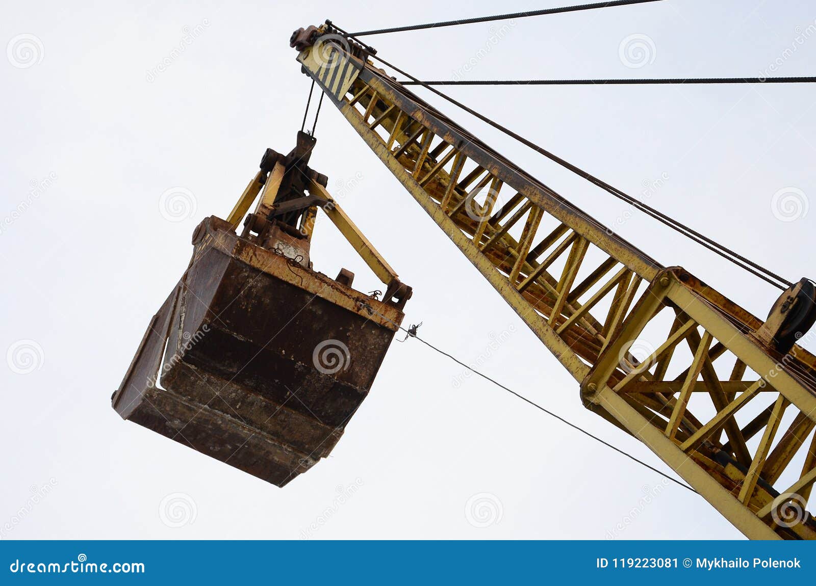Old Yellow Mechanical Clamshell Grab on Blue Sky Background Stock Image ...