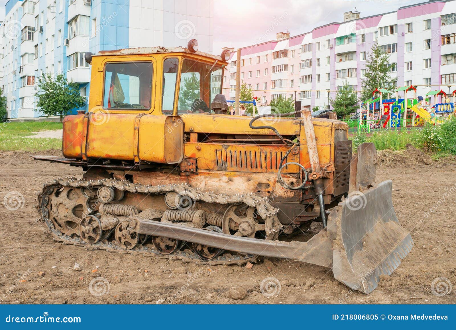 An Old Yellow Rusty Excavator is Clearing a Plot of Land. the Excavator ...
