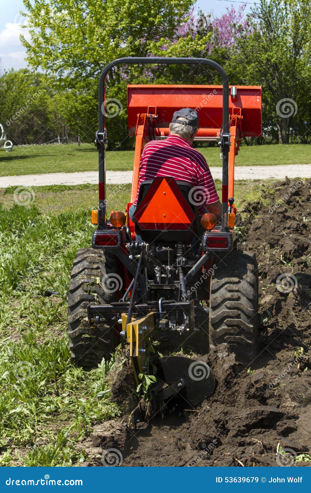 Older Farmer Plowing His Garden Stock Image - Image of tractor, plants ...