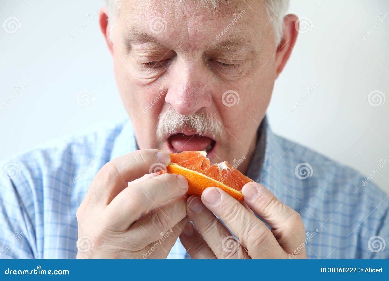 Older man eating orange stock photo. Image of healthy - 30360222
