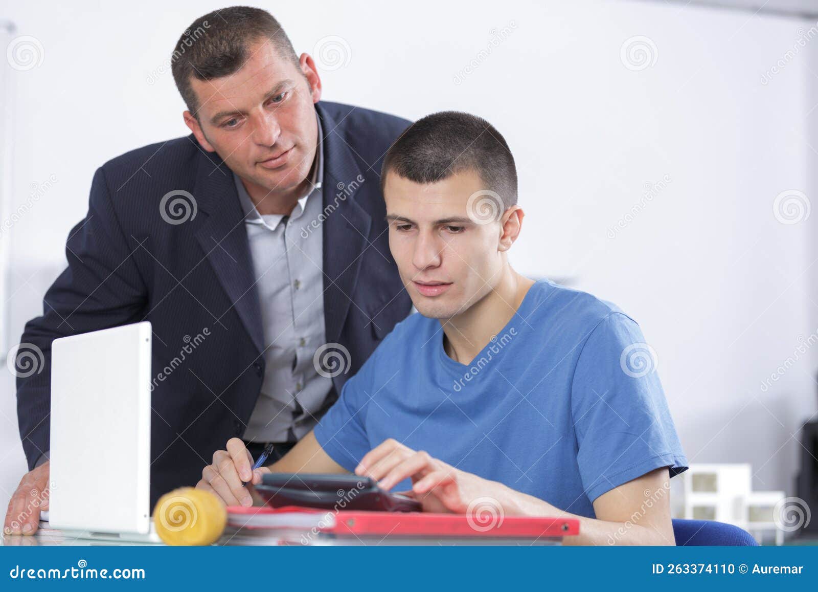 Older Man Helping Younger Man on Computer Stock Photo - Image of ...